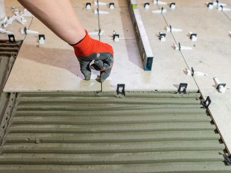 Workers Hands with Ceramic Tiles and Tools for Tiler. Floor Tiles ...