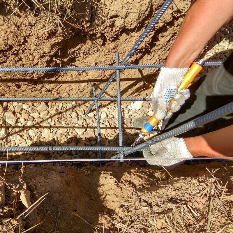 Workers Hands Using Steel Wire and Pincers To Secure Rebar before ...