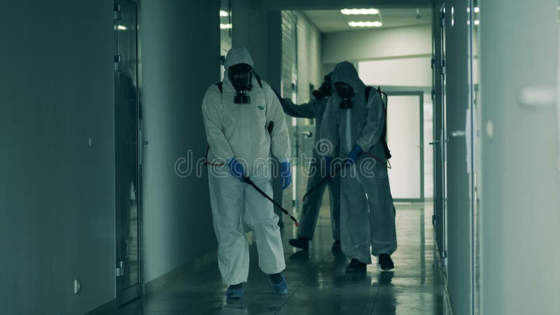 Workers in Hazmat Suits are Sanitizing a Corridor Stock Footage - Video ...