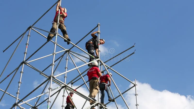Workers in Helmets Working on Tall Scaffolding Stock Video - Video of ...