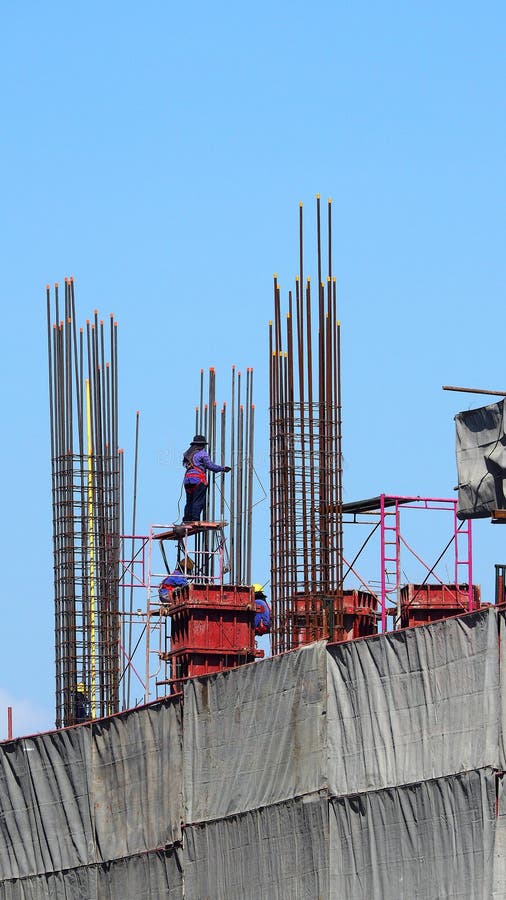 Workers on High Building Construction Site. Stock Photo - Image of ...