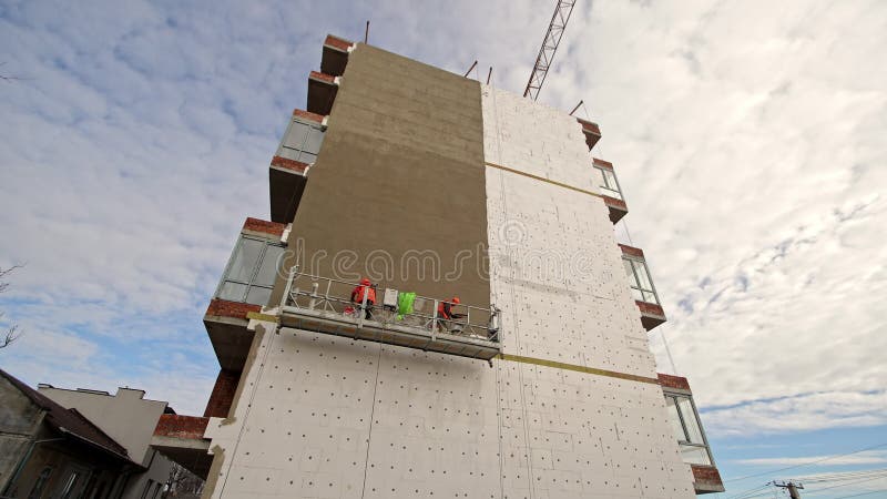Workers on a High-Rise Building Facade, Construction Workers in Safety ...
