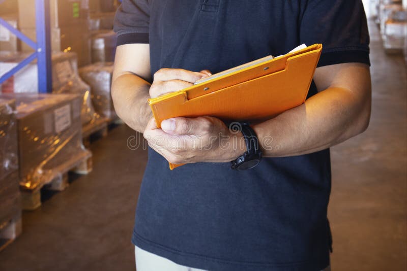 Workers Holding Clipboard is Checking Packaging Boxes in Storage ...
