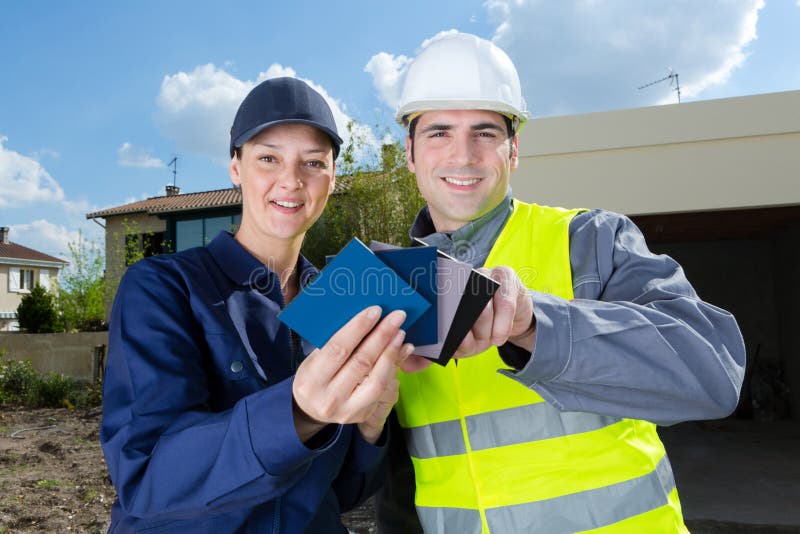 Workers Holding Color Guide for Exterior House Paint Stock Photo ...