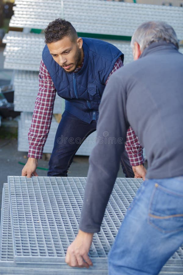 Workers Holding Sheet Metal Plates Outside Factory Stock Image - Image ...