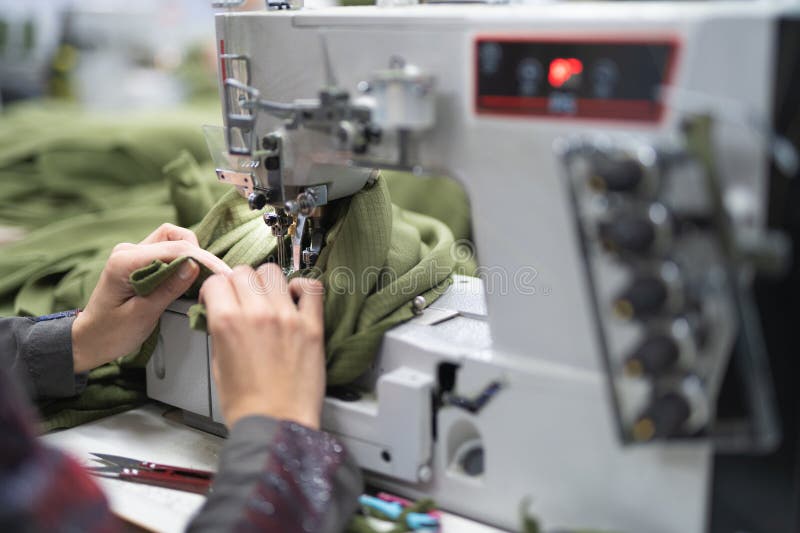 Workers in an Industrial Garment Factory Sew Clothes on Sewing Machine ...