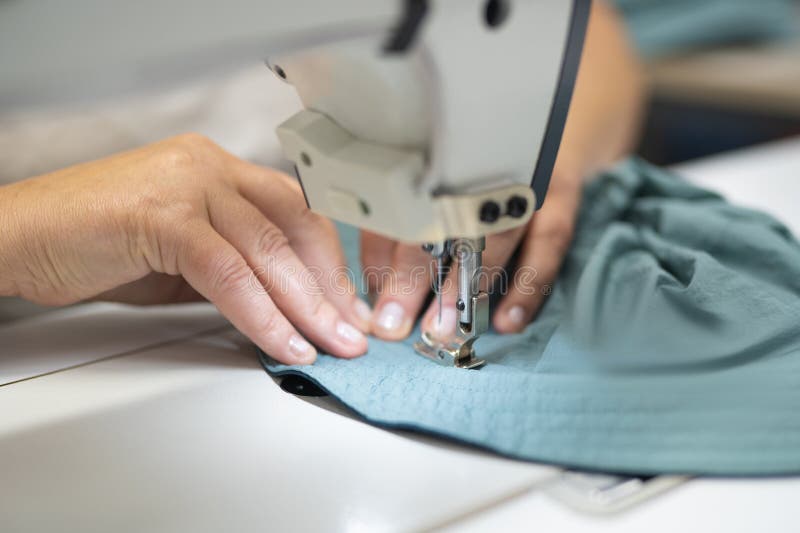 Workers in an Industrial Garment Factory Sew Clothes on Sewing Machine ...