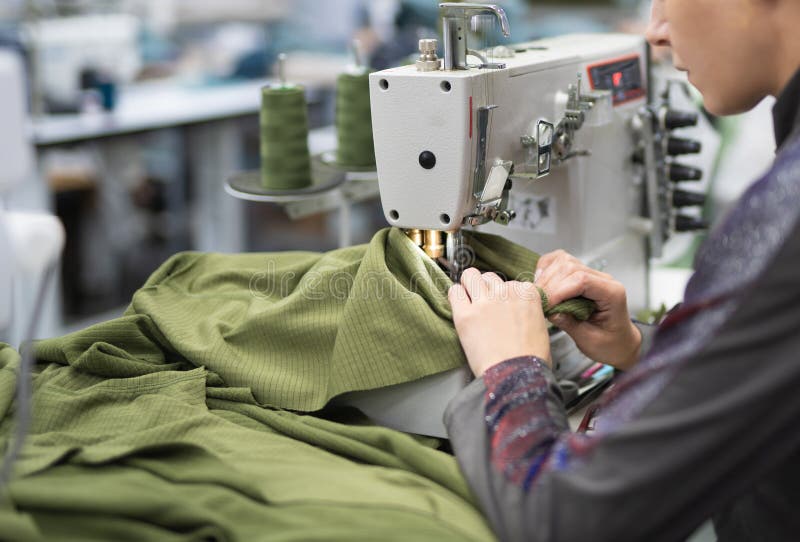 Workers in an Industrial Garment Factory Sew Clothes on Sewing Machine ...