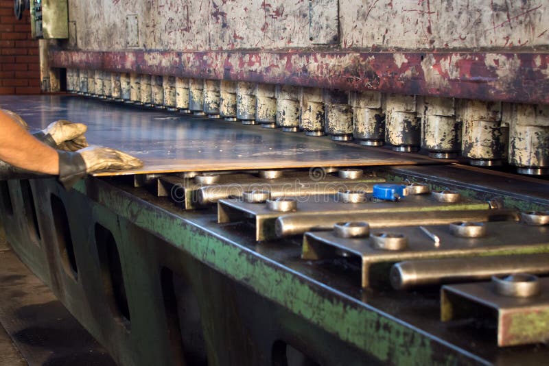 Workers Inserting Metal Plate into Compression Machine Stock Image ...