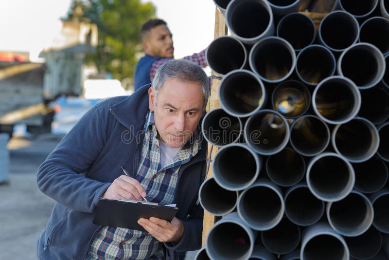 Workers Inspecting Pipes in Yard Stock Image - Image of pipeline ...