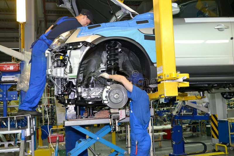 Workers Install the Engine on the Car. Assembly Conveyor of Auto ...