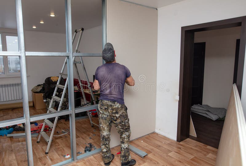 Workers Install Plasterboard Wall in the Room Stock Photo - Image of ...