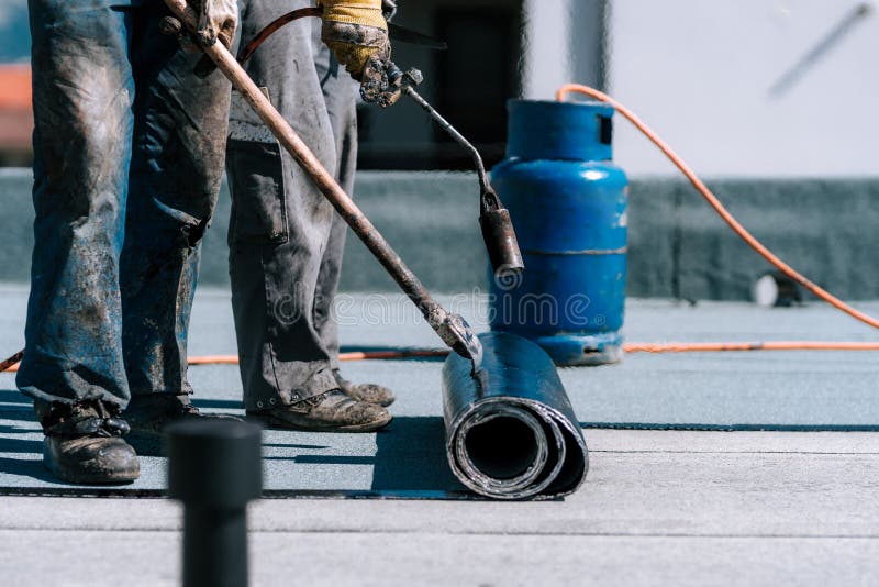 Workers Installing Rolls of Bituminous Waterproofing Membrane for the ...