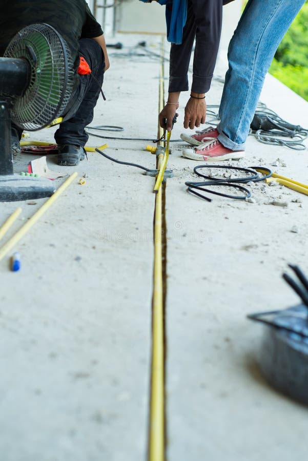 Workers Installing the Electrical Wire and Pipe in the House Under ...