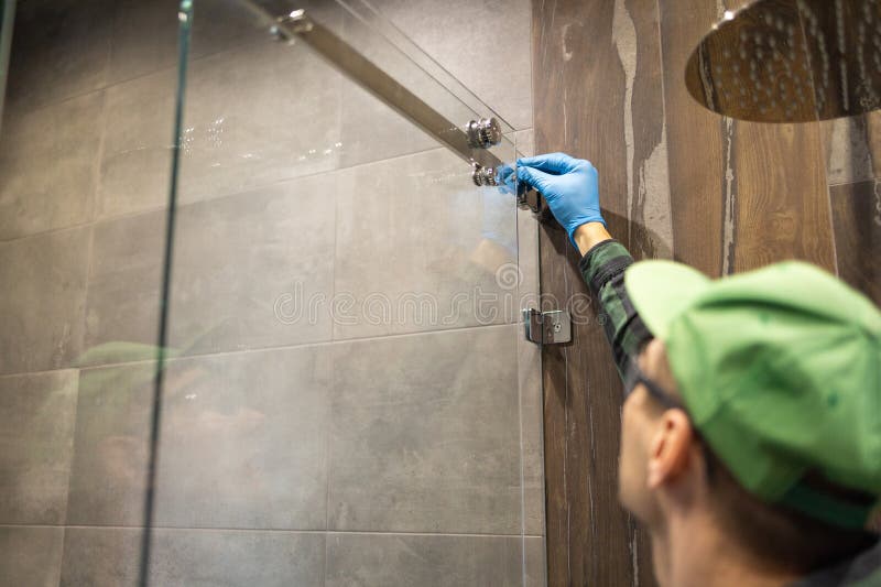 Workers are Installing Glass Door of the Shower Enclosure. Stock Photo ...