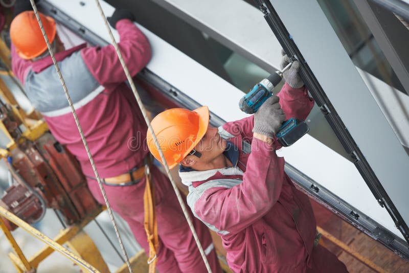 Workers Installing Glass Window on Building Stock Photo - Image of ...