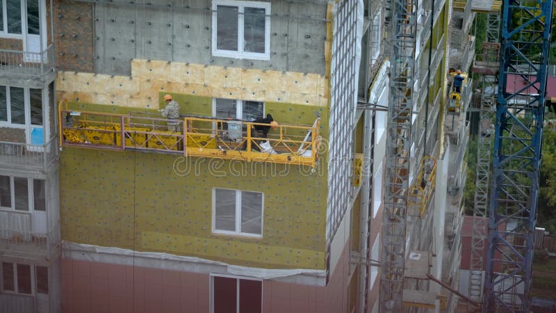 Workers Installing Insulation at Construction Site of High-rise ...