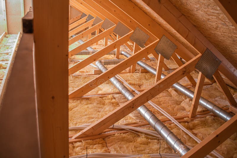 Wooden Rafters and Insulation in a Residential Attic Under Construction ...