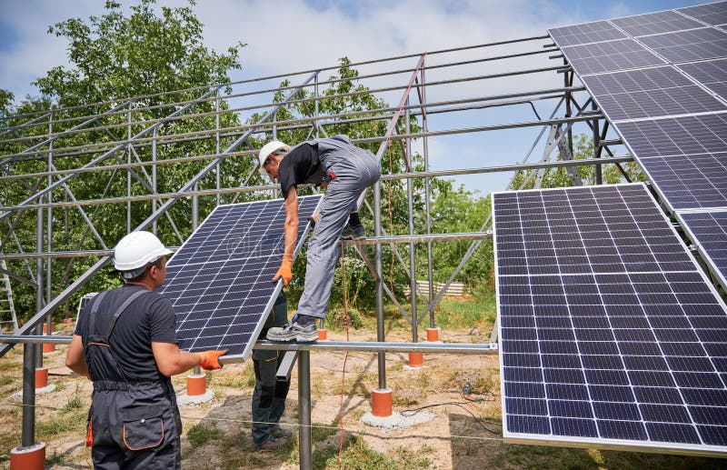 Men Workers Installing Solar Panels on Roof of House. Stock Image ...