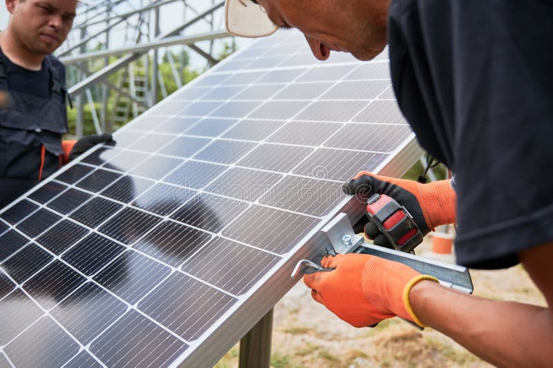Men Workers Installing Solar Panels on Roof of House. Stock Image ...
