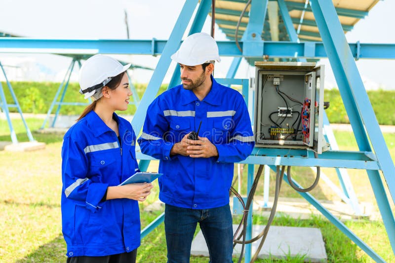 Workers Installing Solar Panels, Engineer Team at Solar Panel Farm ...