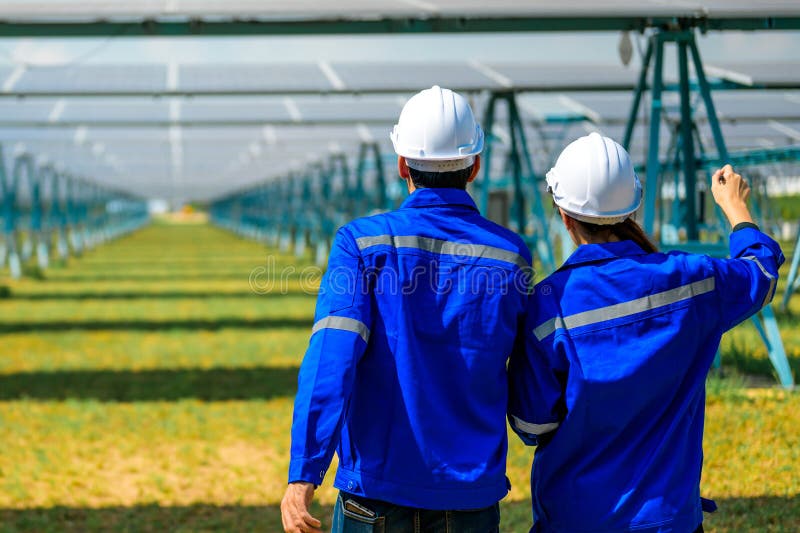 Workers Installing Solar Panels, Engineer Team at Solar Panel Farm ...