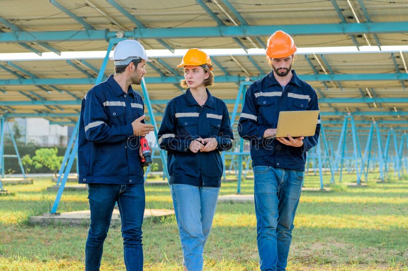 Workers Installing Solar Panels, Engineer Team at Solar Panel Farm ...