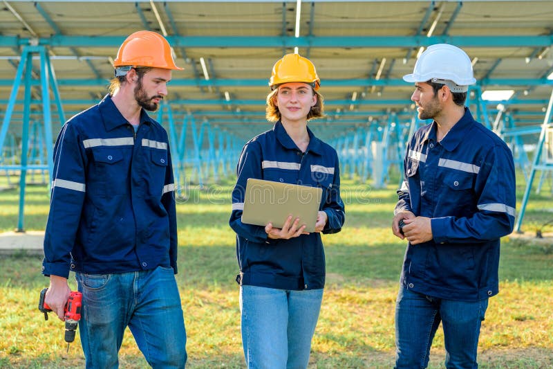 Workers Installing Solar Panels, Engineer Team at Solar Panel Farm ...