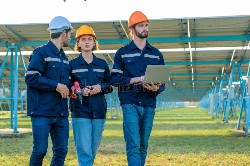 Workers Installing Solar Panels, Engineer Team at Solar Panel Farm ...