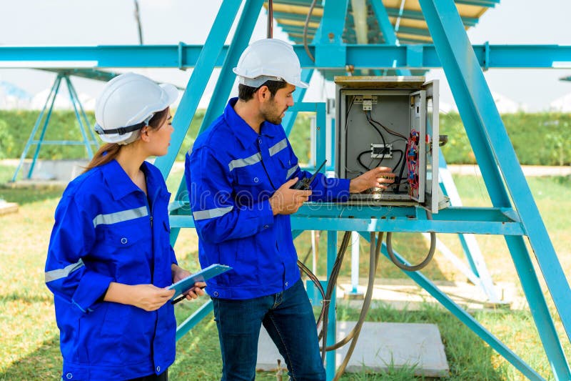 Workers Installing Solar Panels, Engineer Team at Solar Panel Farm ...