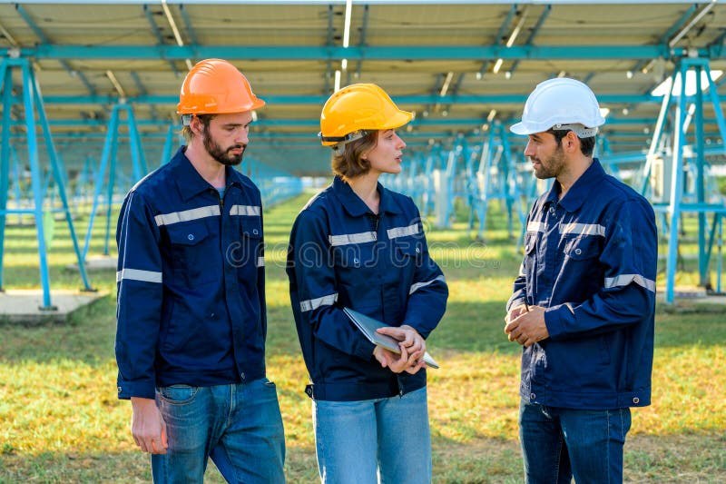 Workers Installing Solar Panels, Engineer Team at Solar Panel Farm ...