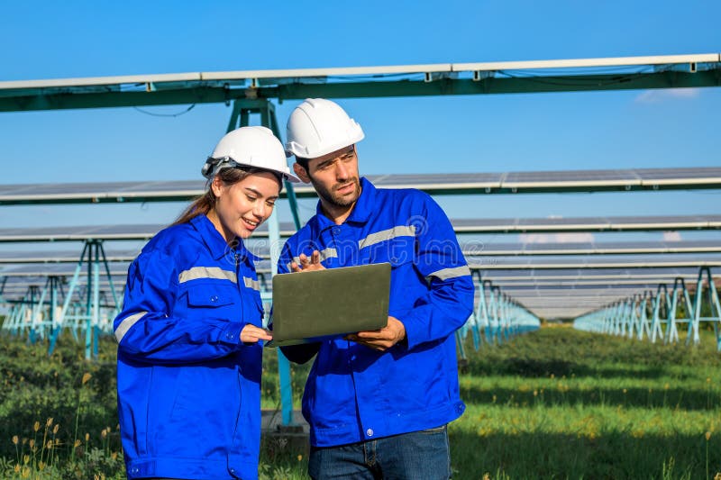 Workers Installing Solar Panels, Engineer Team at Solar Panel Farm ...