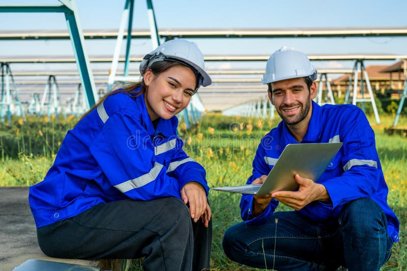 Workers Installing Solar Panels, Engineer Team at Solar Panel Farm ...