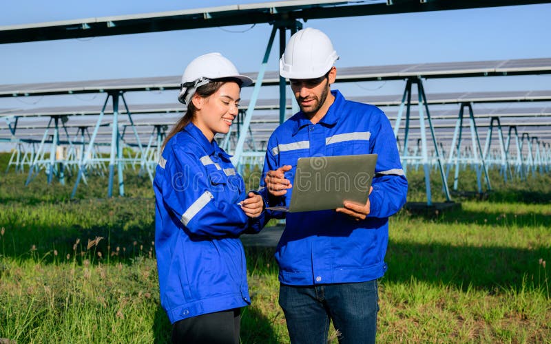 Workers Installing Solar Panels, Engineer Team at Solar Panel Farm ...