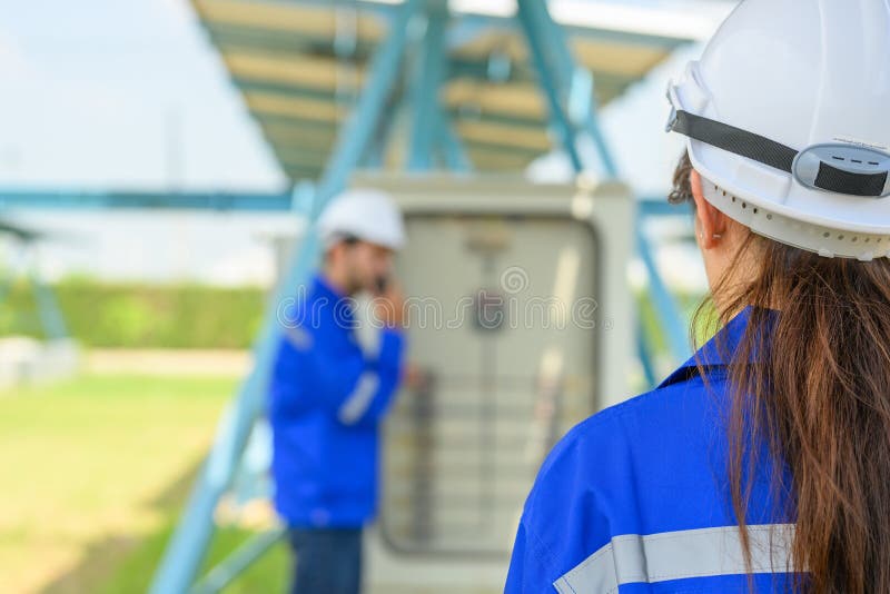 Workers Installing Solar Panels, Engineer Team at Solar Panel Farm ...
