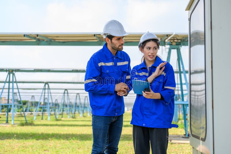 Workers Installing Solar Panels, Engineer Team at Solar Panel Farm ...