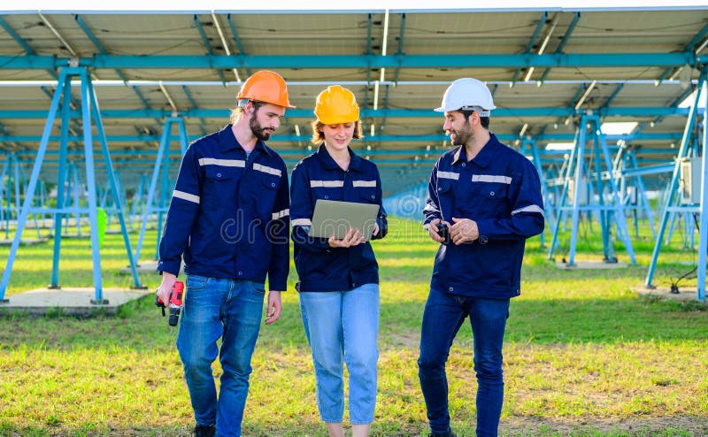 Workers Installing Solar Panels, Engineer Team at Solar Panel Farm ...