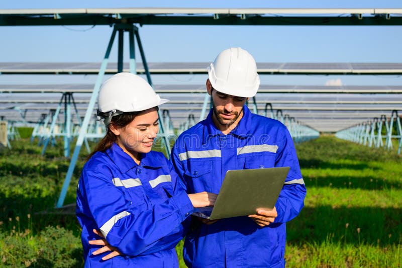 Workers Installing Solar Panels, Engineer Team at Solar Panel Farm ...