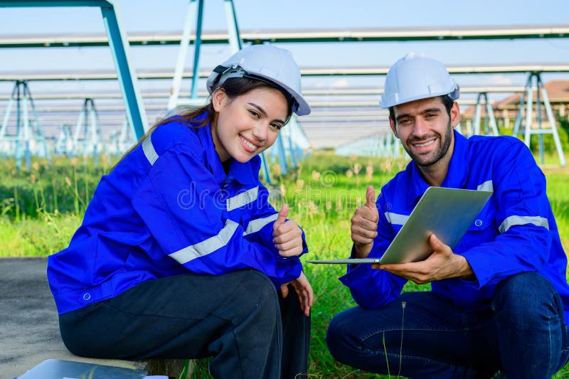 Workers Installing Solar Panels, Engineer Team at Solar Panel Farm ...