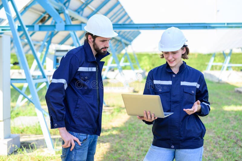 Workers Installing Solar Panels, Engineer Team at Solar Panel Farm ...