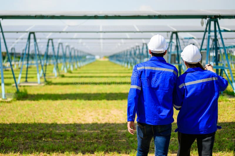 Workers Installing Solar Panels, Engineer Team at Solar Panel Farm ...