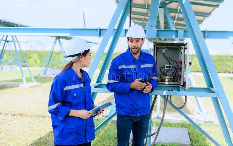 Workers Installing Solar Panels, Engineer Team at Solar Panel Farm ...