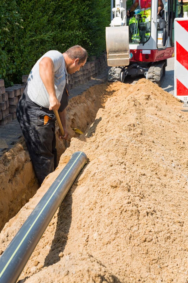 Workers Installing Underground Optical Fiber Cables Stock Image - Image ...