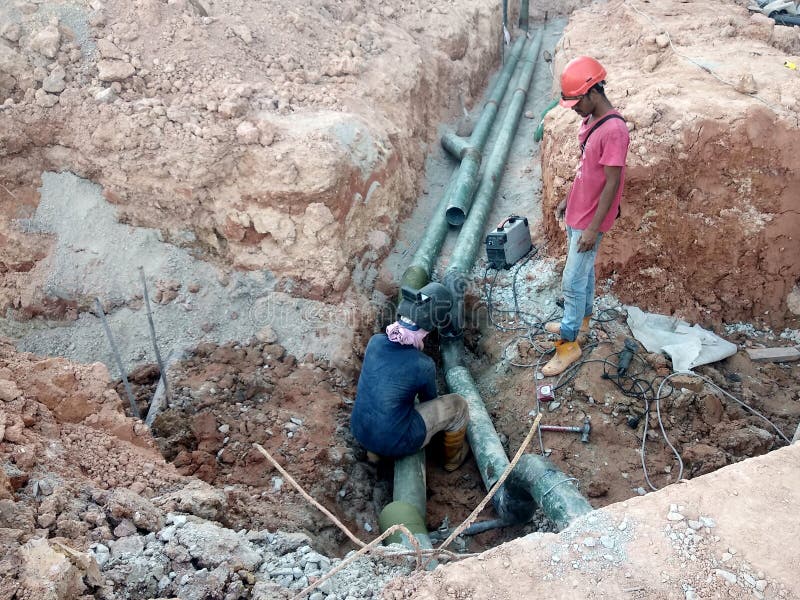 Workers Installing Underground Utility and Services Pipe in the Shallow ...