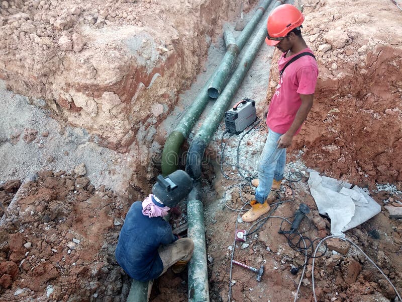 Workers Installing Underground Utility and Services Pipe in the Shallow ...