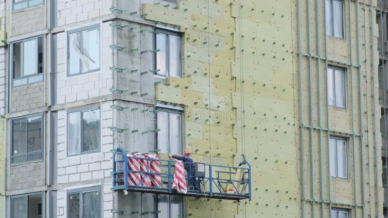 Workers are Insulating the Wall of a Building. Construction Site ...