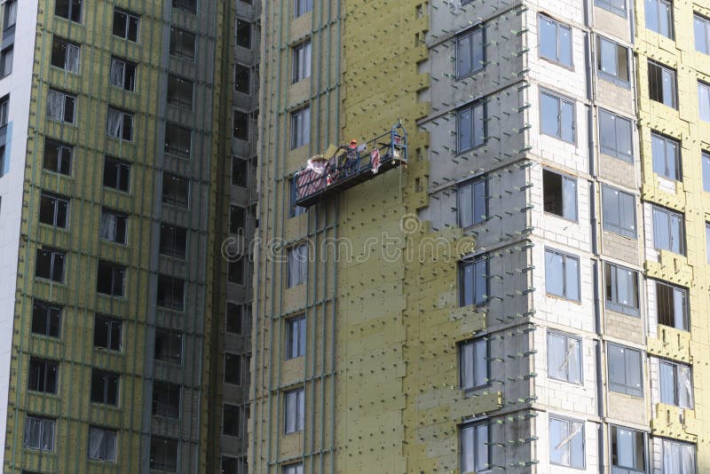 Workers are Insulating the Wall of a Building. Construction Site ...