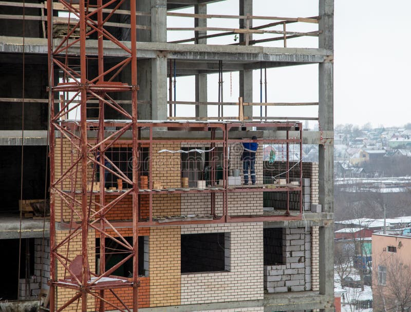Workers Lay Brick Walls at the Construction Site of a Multi-storey ...