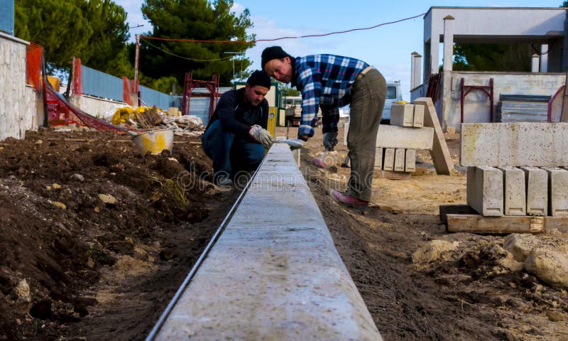 Workers Laying Concrete Curbs Stock Photo - Image of accuracy, curb ...