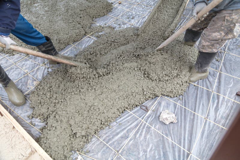 Workers Level Out the Concrete Mix at a Construction Site. Stock Image ...